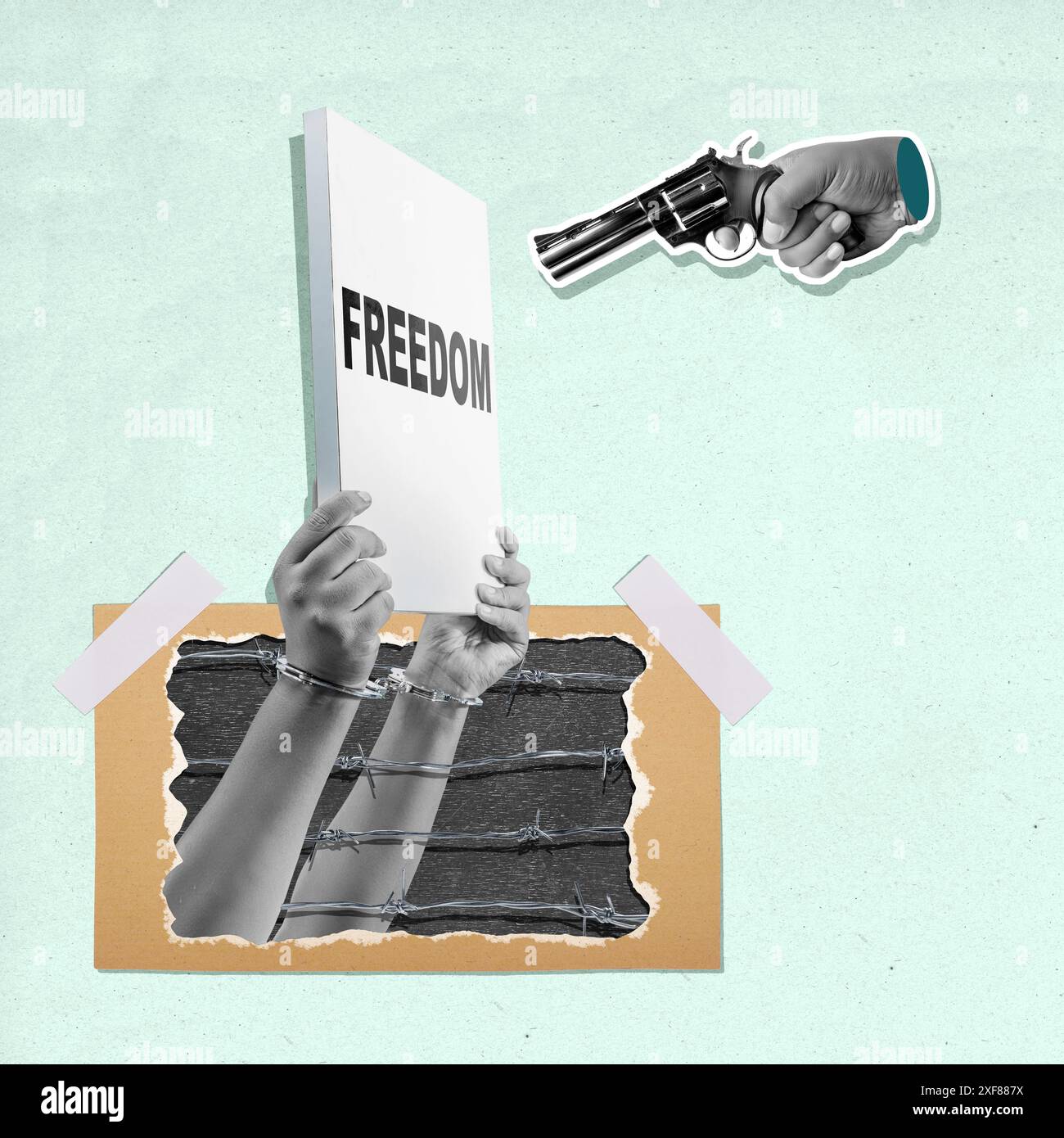 The gun aims at a human hand with a handcuff in the middle of barbed ...