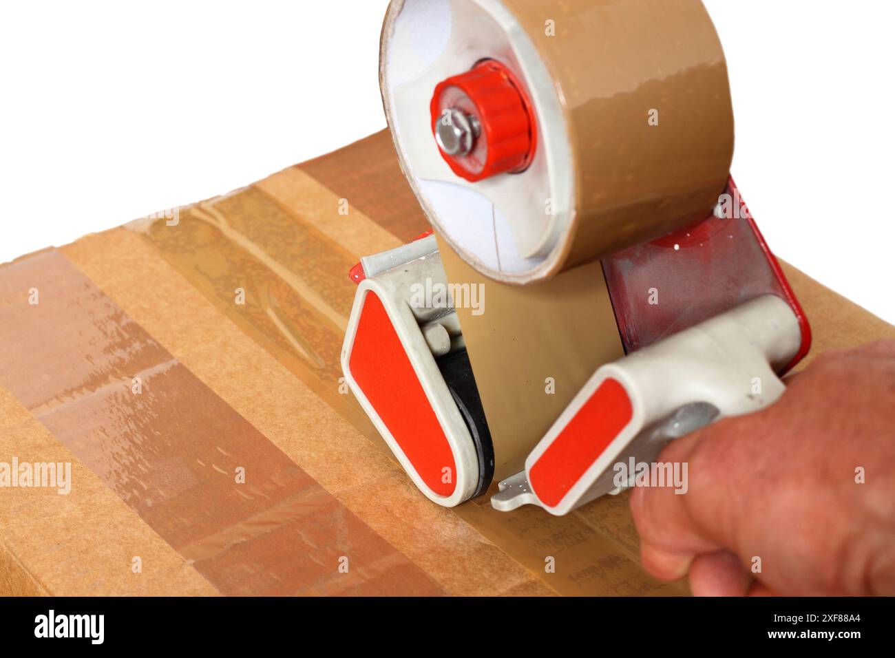 Taping a cardboard box with a tape dispenser getting ready for shipping ...