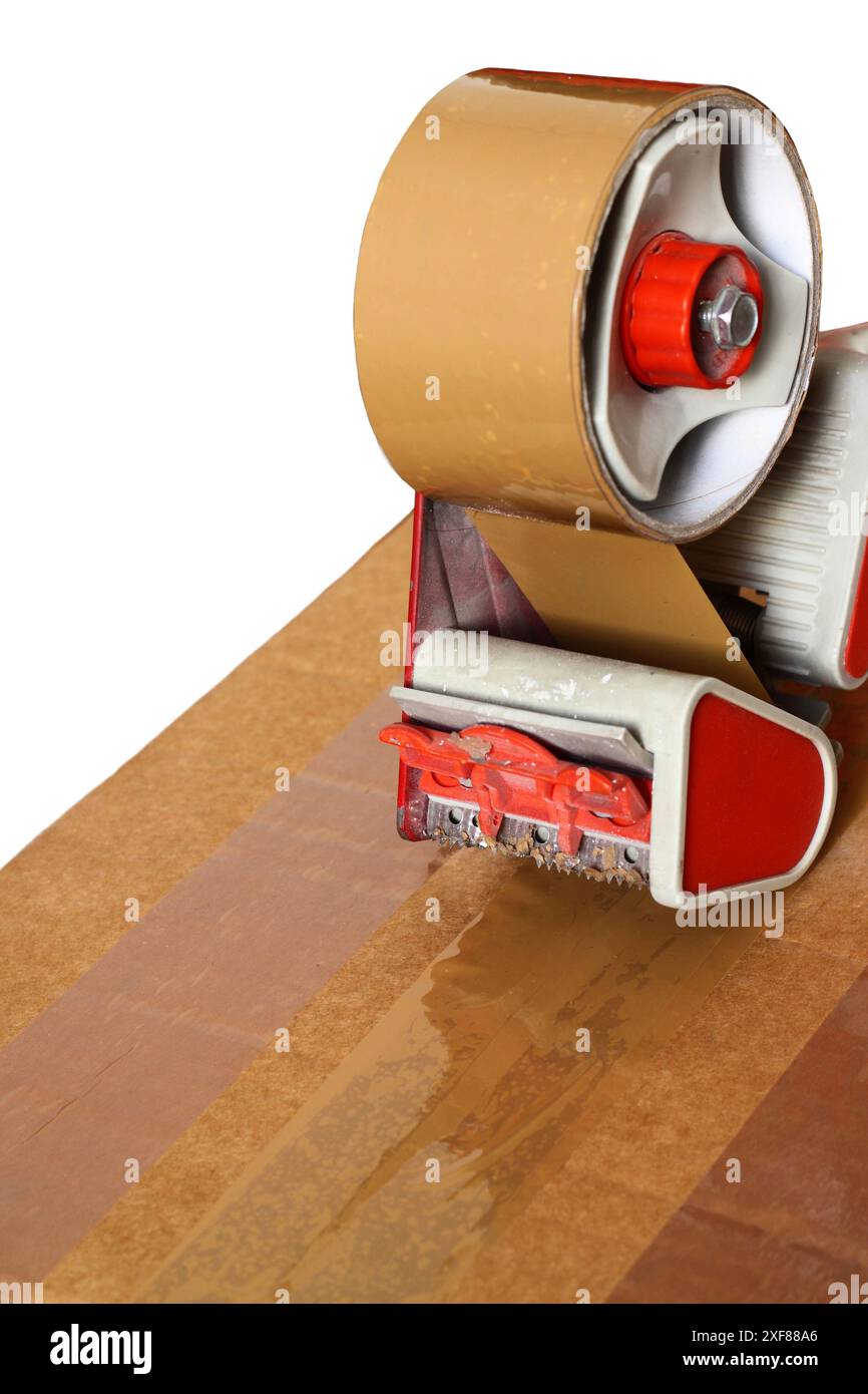Taping a cardboard box with a tape dispenser getting ready for shipping ...