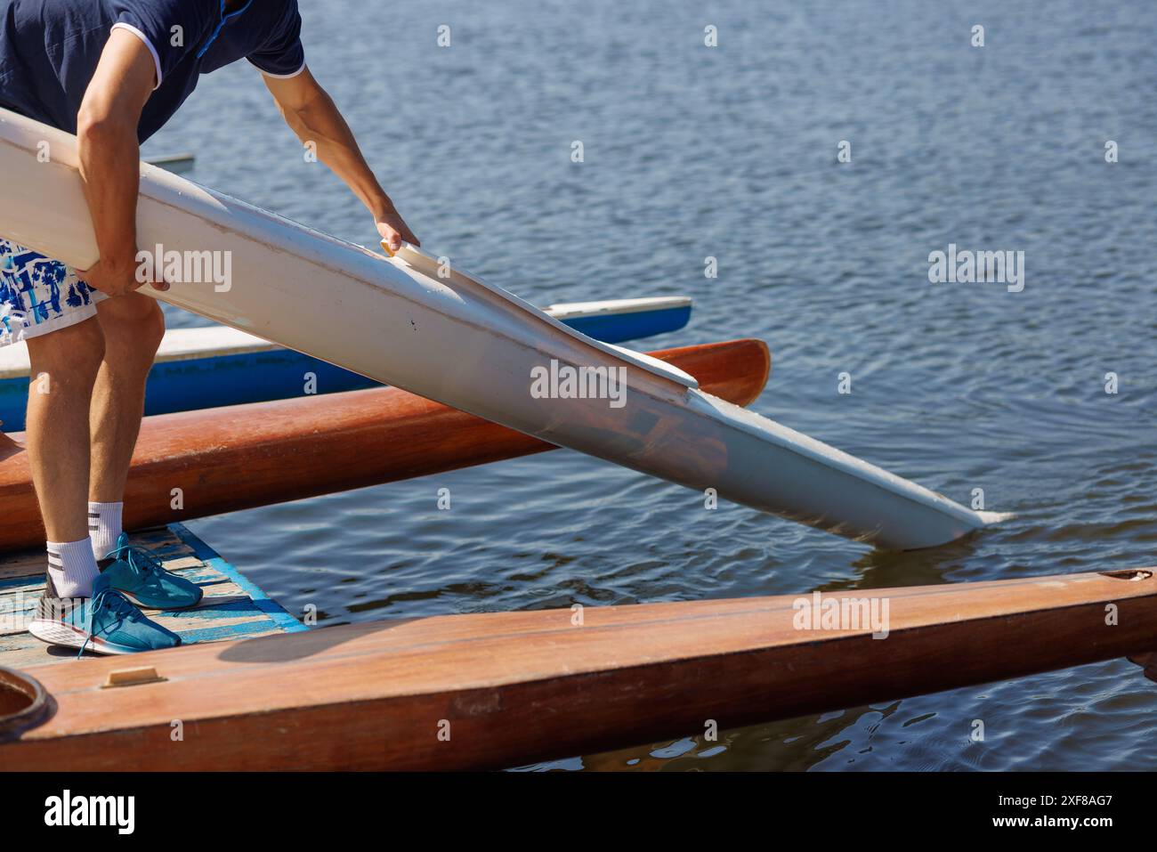 athlete putting on water kayak, water sport, kayaking and canoeing ...