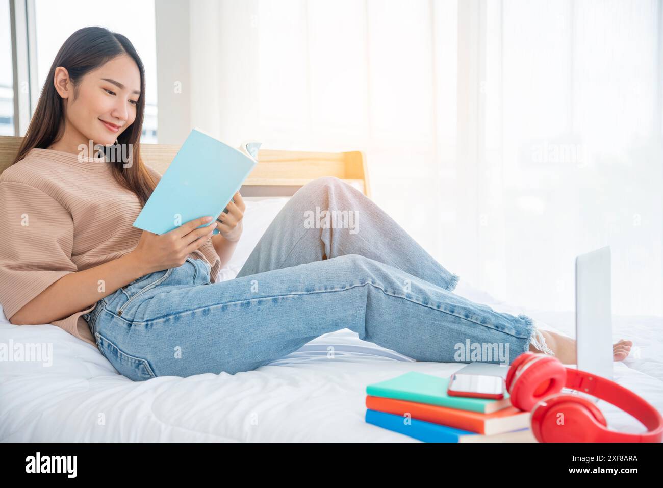 Relax woman holding book read at bookshelf in university library. Young ...