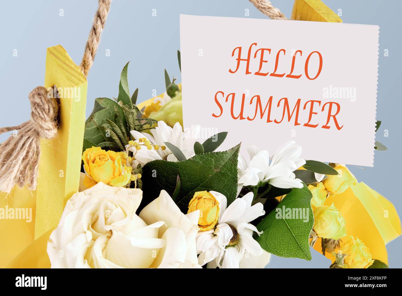 Hello summer words written on a paper note in a bouquet of flowers ...