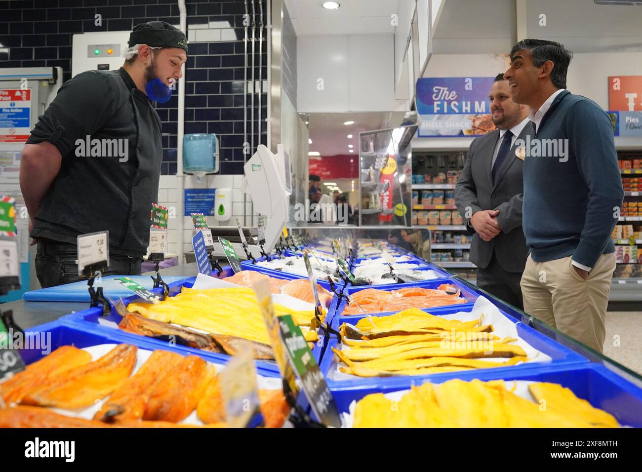 Prime Minister Rishi Sunak at a fish counter during a visit to a ...