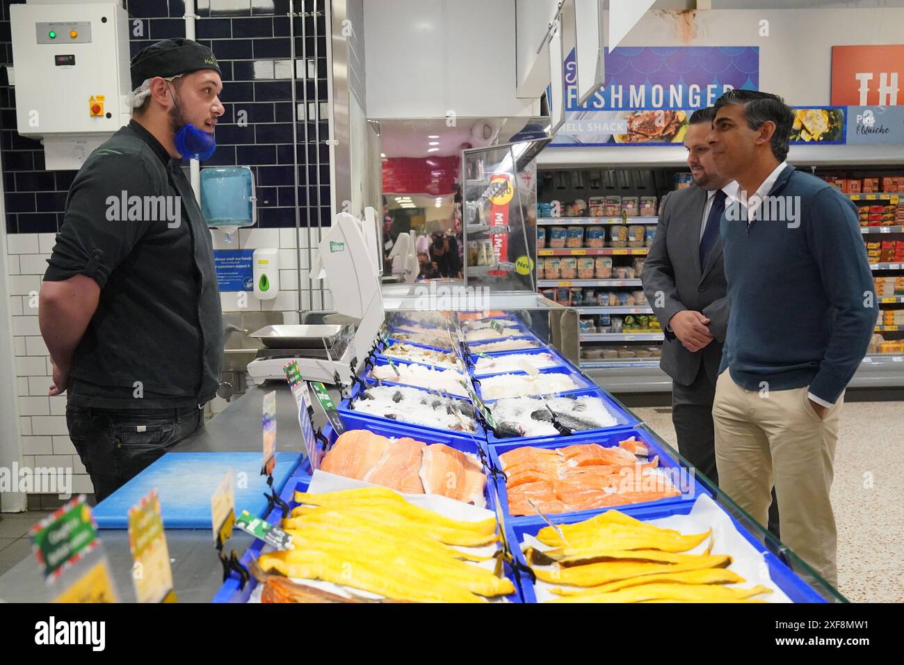 Prime Minister Rishi Sunak at a fish counter during a visit to a ...