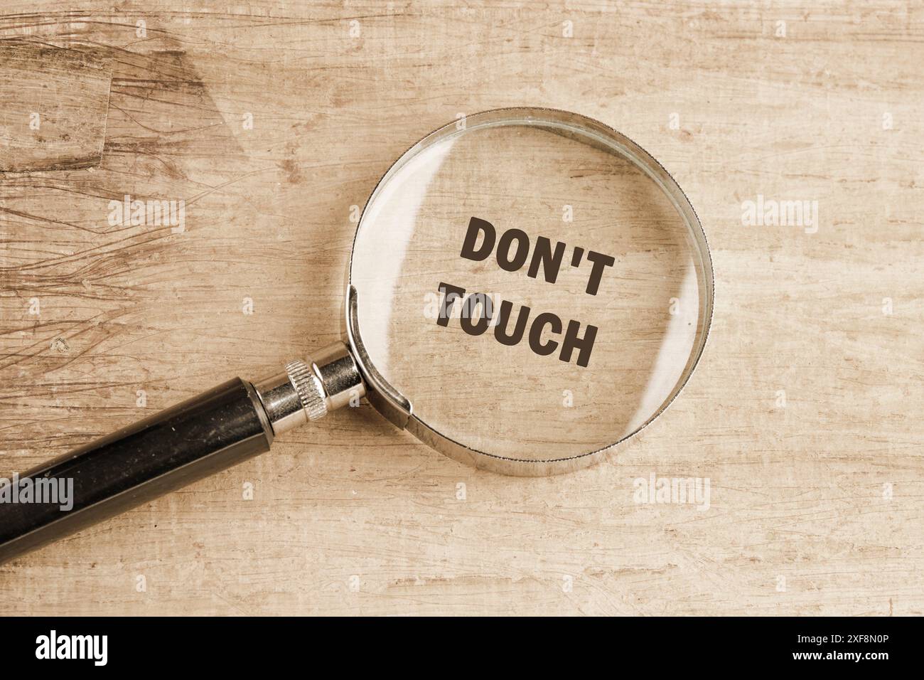Words DO NOT TOUCH written through a magnifying glass on papyrus Stock ...