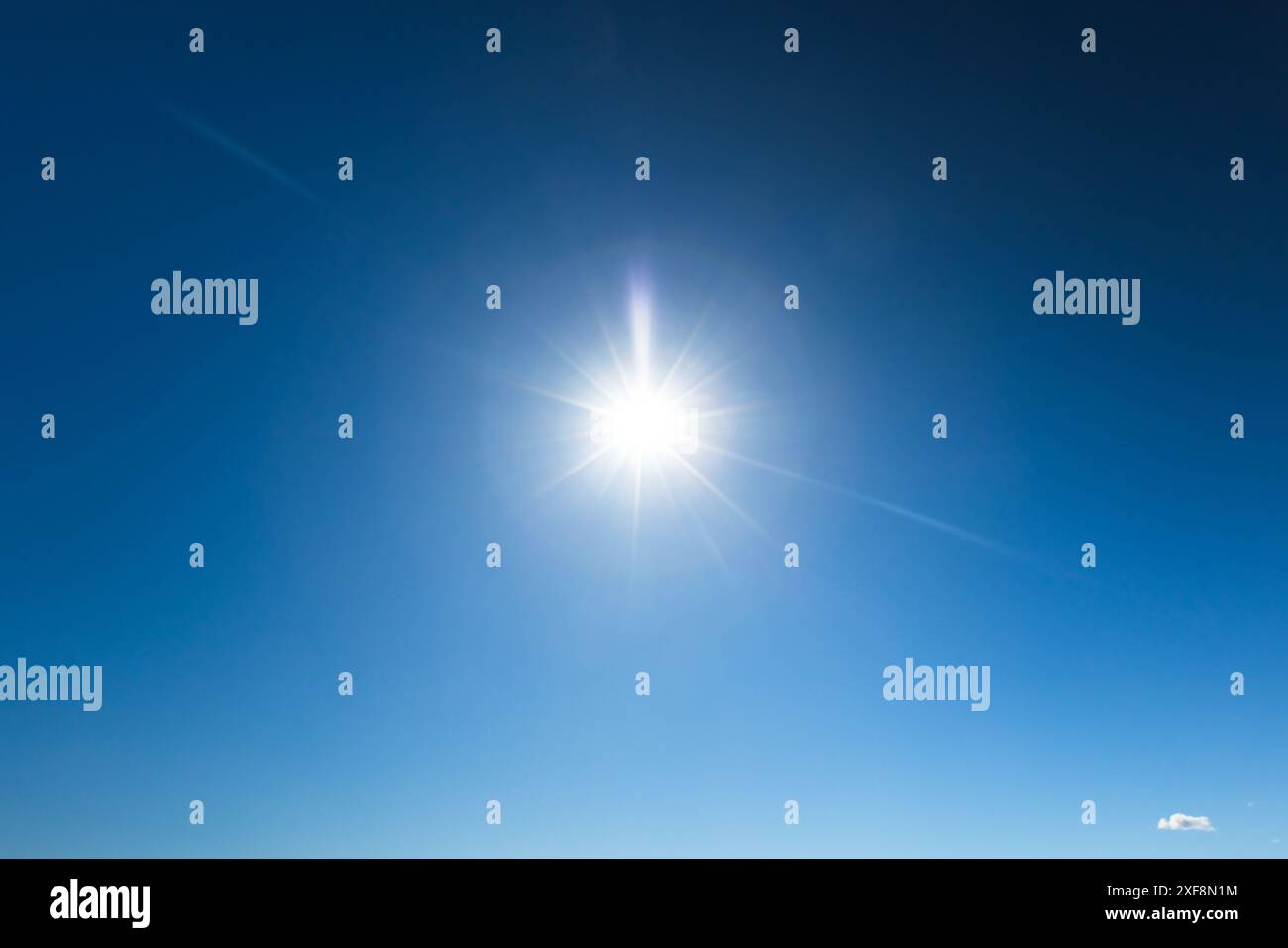Deep blue sky with glowing sun, natural background photo with lens ...