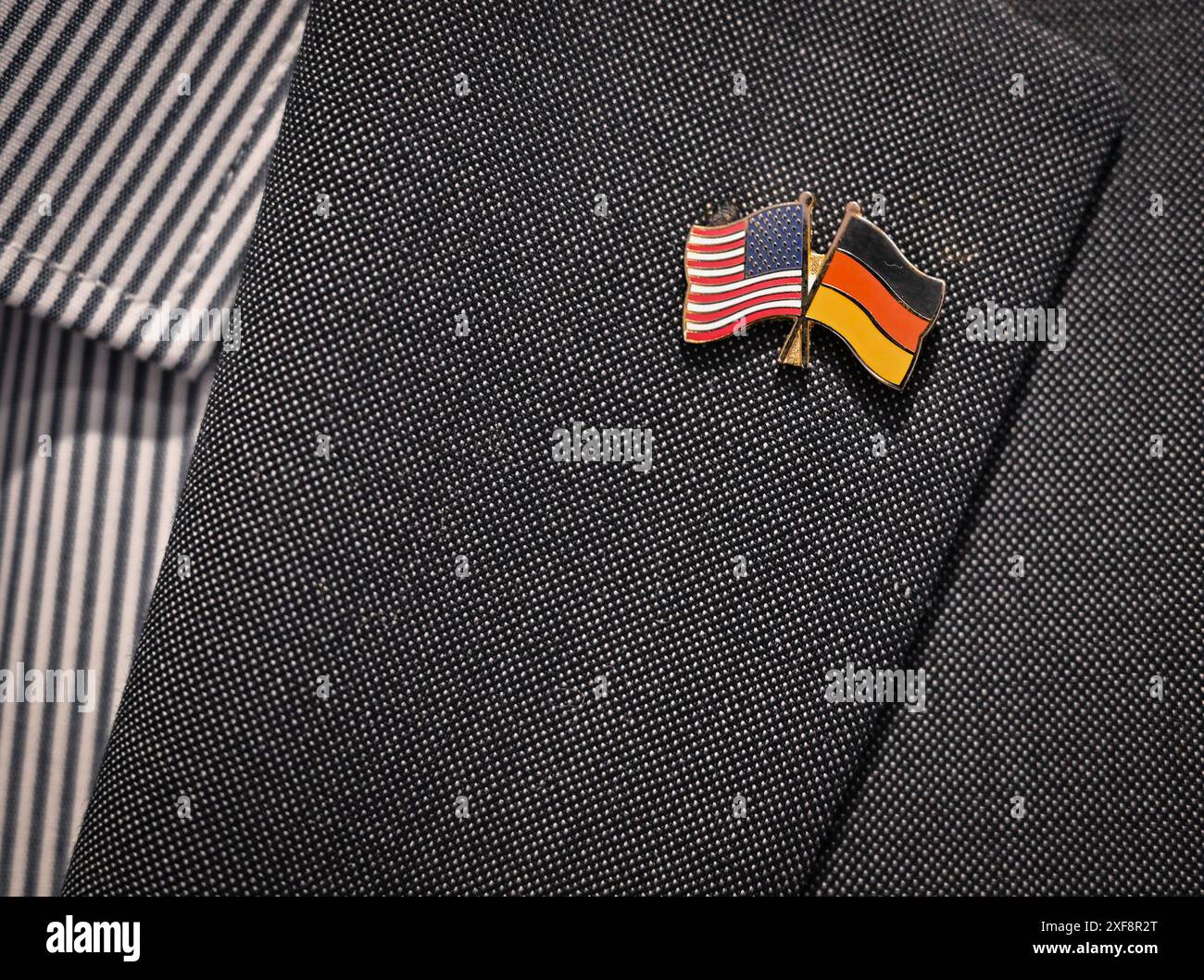 Cottbus, Germany. 01st July, 2024. Two small flags as pins on a suit ...