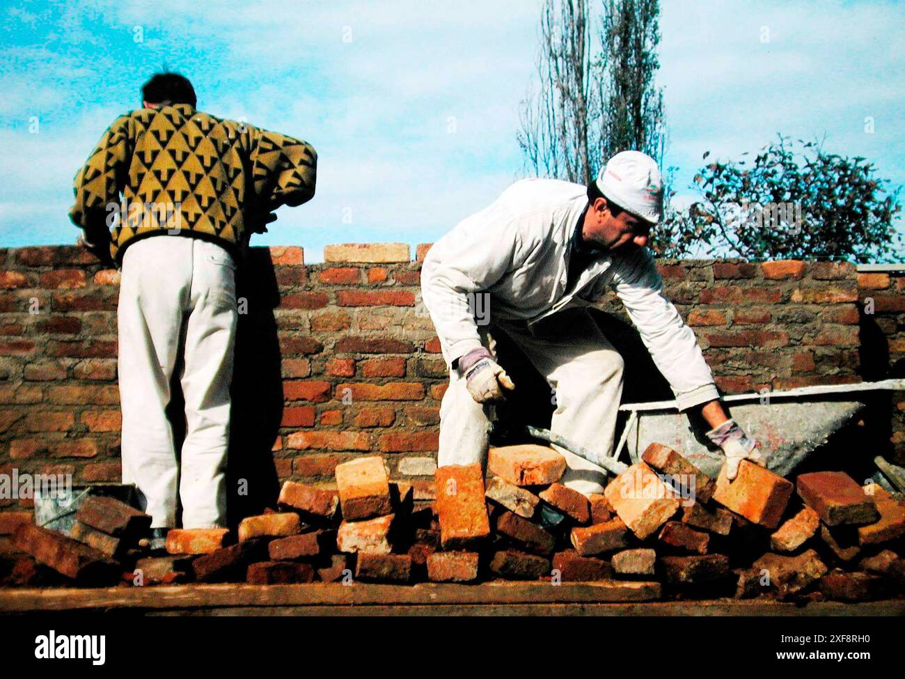 mason builds a brick wall, building work on a construction site mason ...