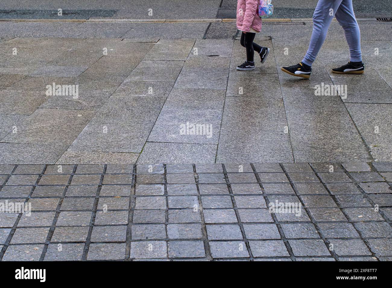 People walking along the pavement sidewalk in Newquay town centre in ...