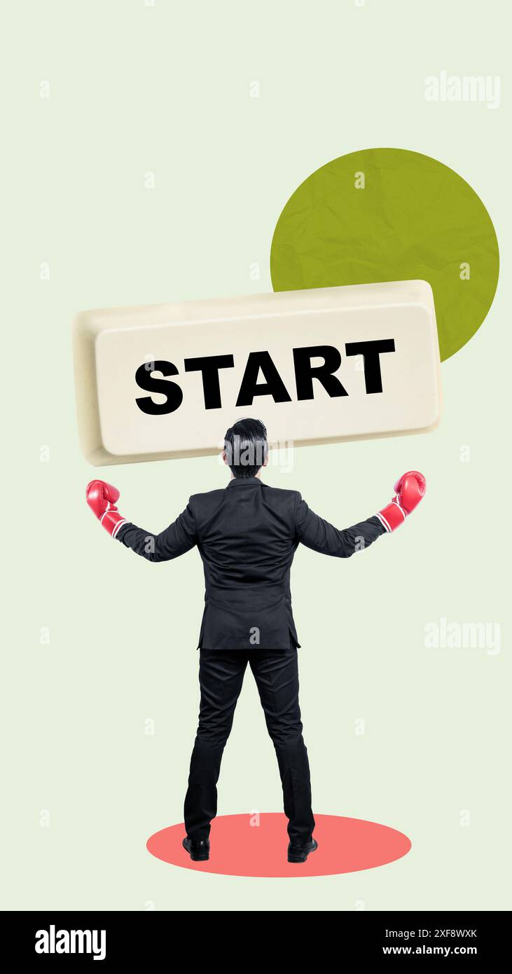 Businessman wearing boxing gloves is raising a giant start key button ...