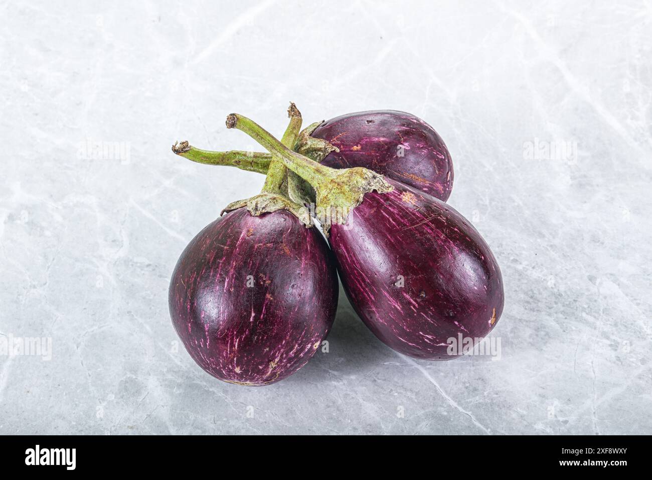 Raw smal asian baby violet eggplant Stock Photo - Alamy