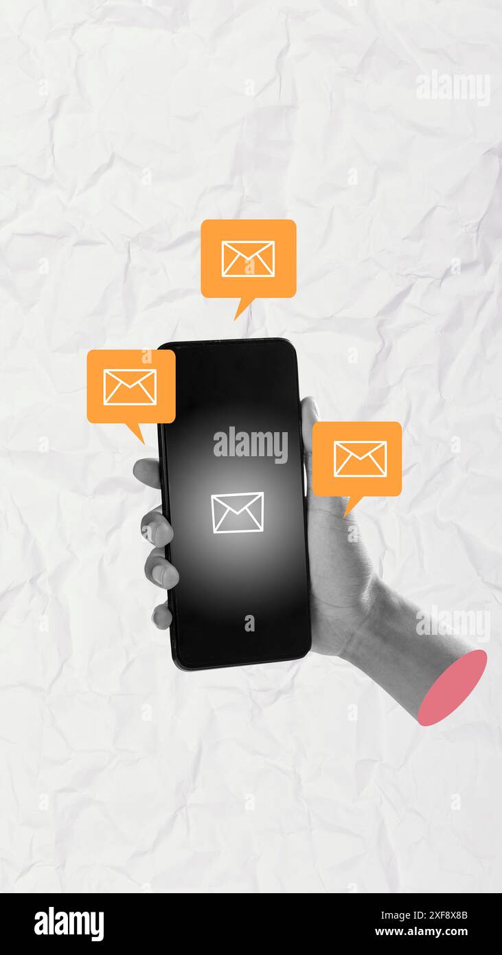 Hand holding smartphone with email notifications on textured paper ...
