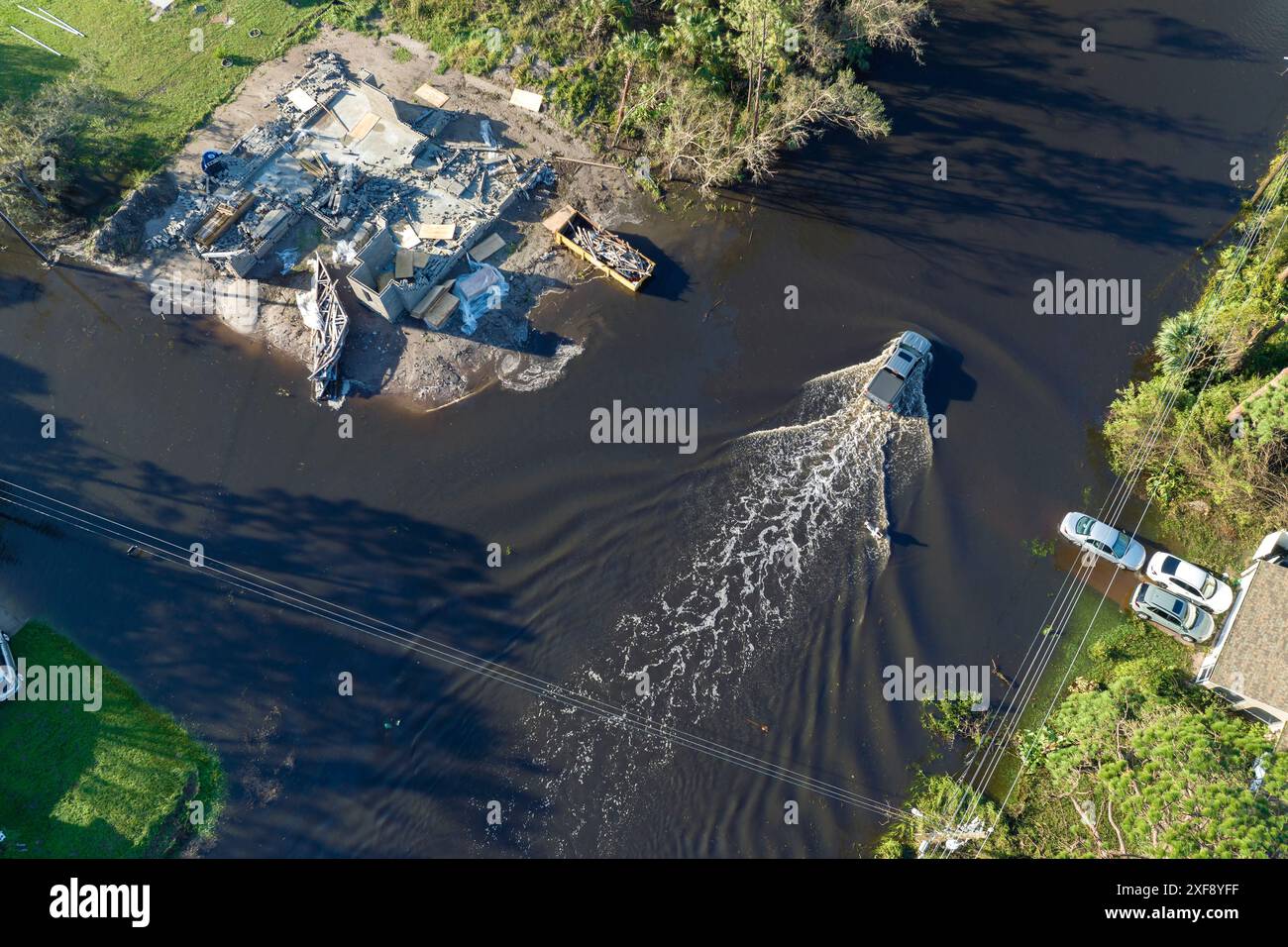 Aerial view of flooded street after hurricane rainfall with driving ...