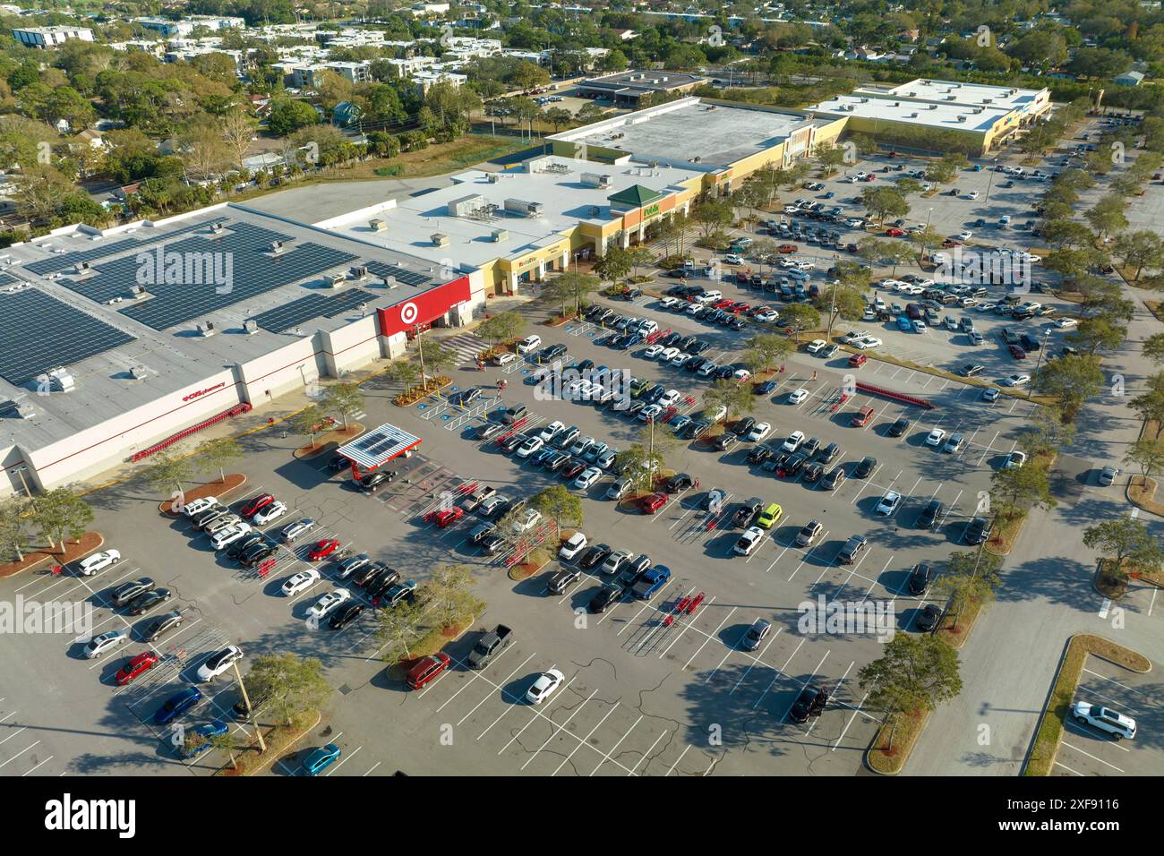 Aerial view of many cars parked on parking lot in front of a grocery ...