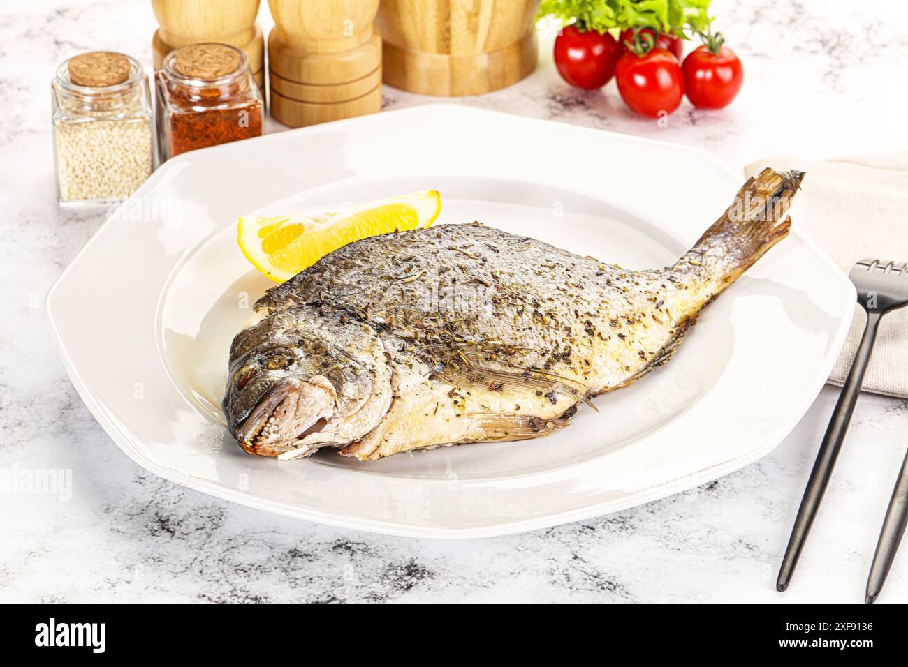 Baked Dorado fish served lemon slice Stock Photo - Alamy