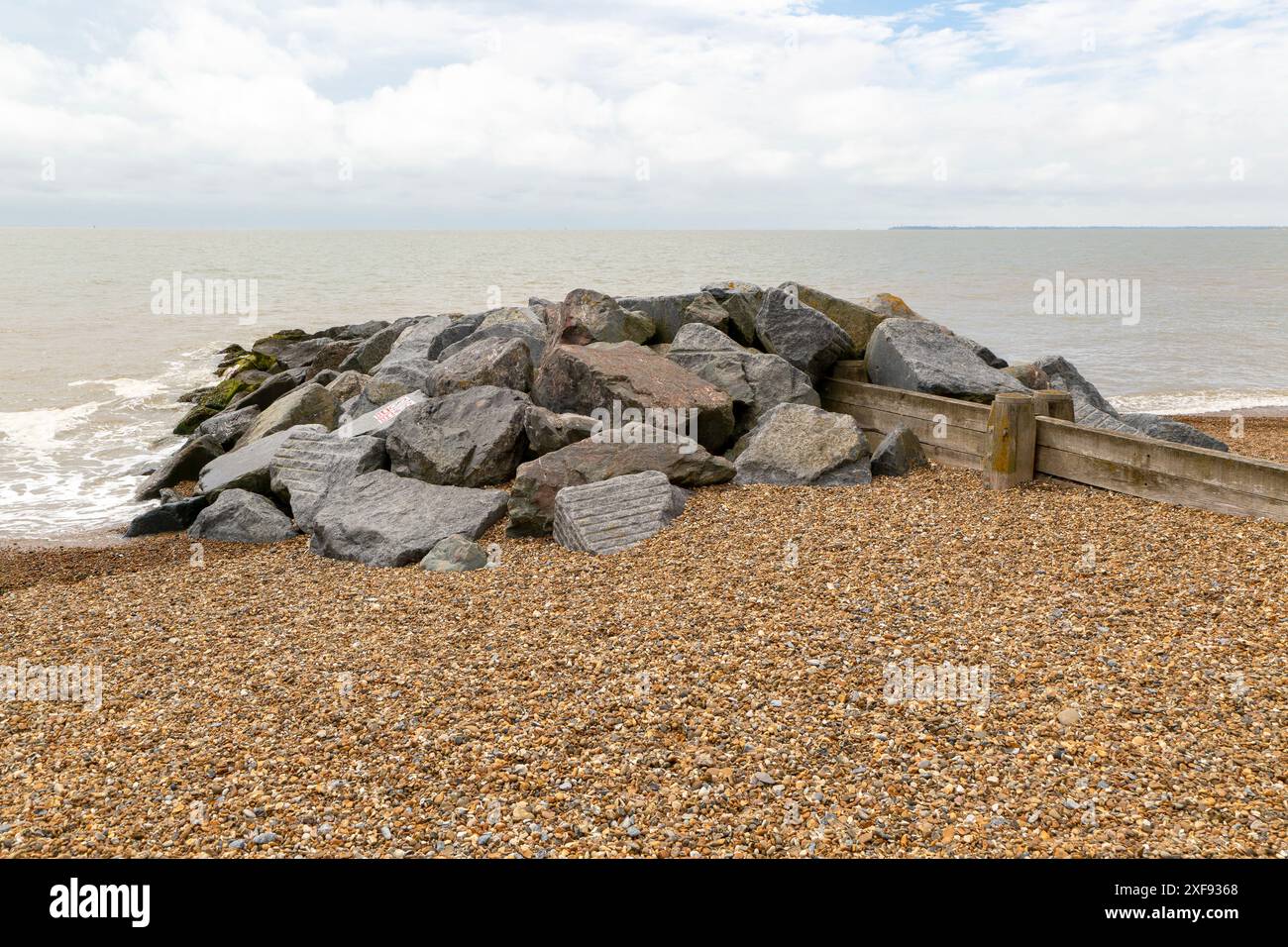 Rock armour groynes on beach managing longshore drift, Felixstowe ...