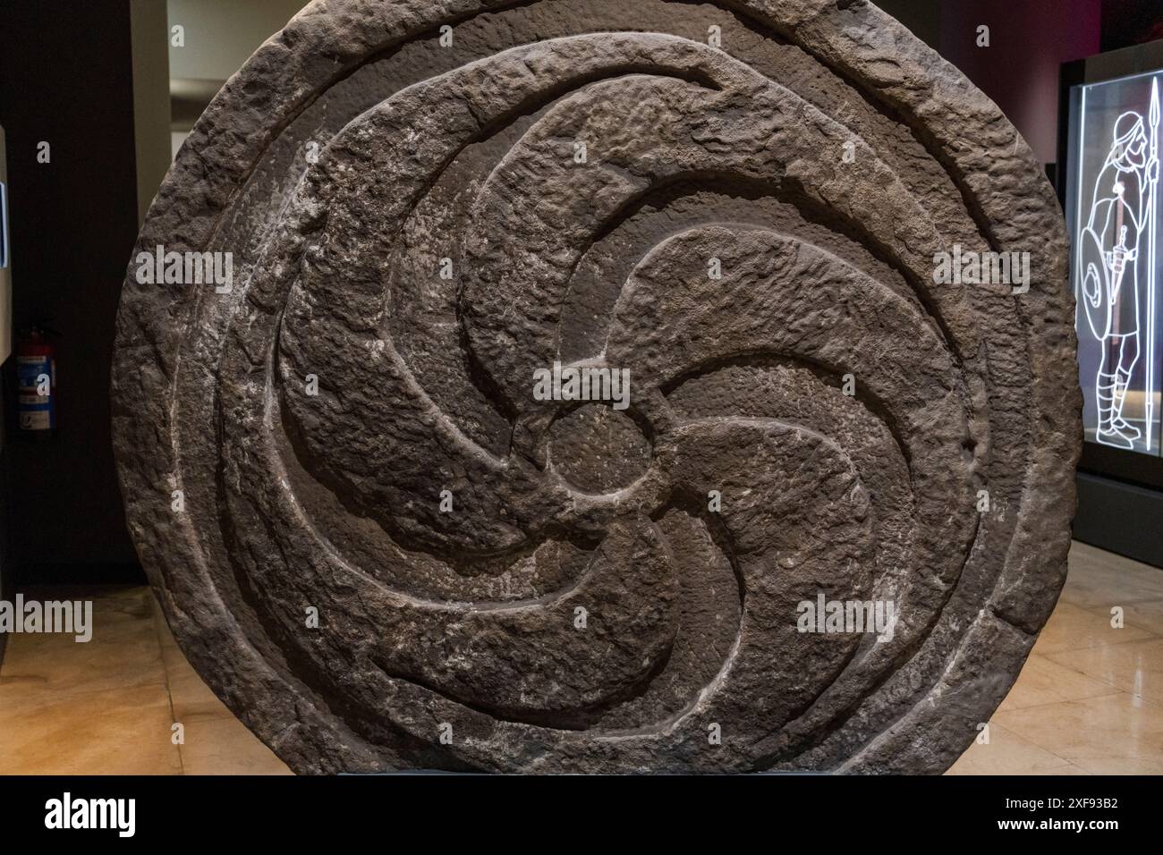 five-armed swastika in relief, second Lombera stele, giant disc-shaped ...