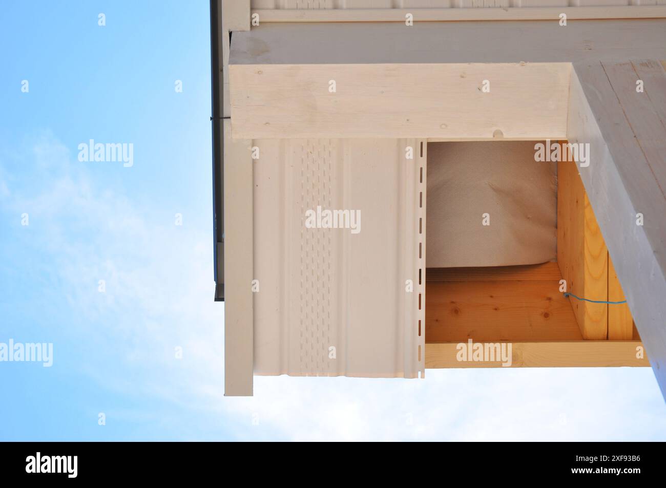 Close up on soffit board installation on the house roof corner. Fascia ...