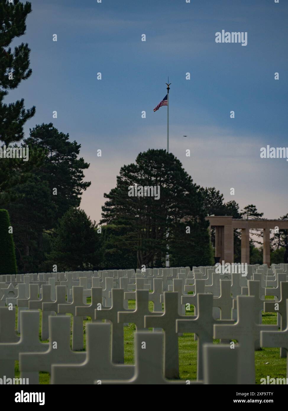 A serene view of the Normandy American Cemetery with rows of white ...