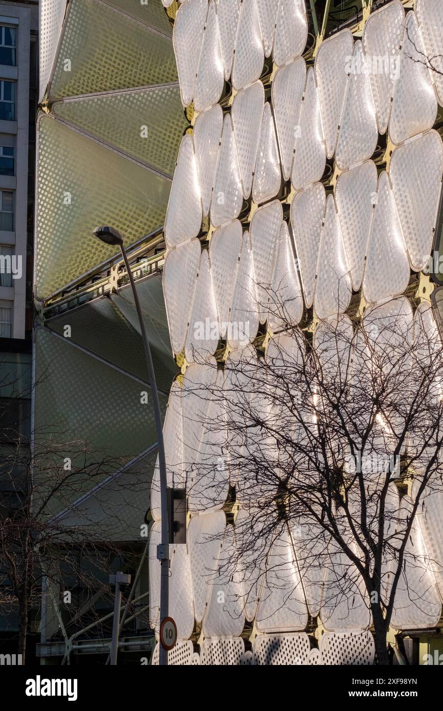 Modern building facade with white geometric patterns and exposed ...