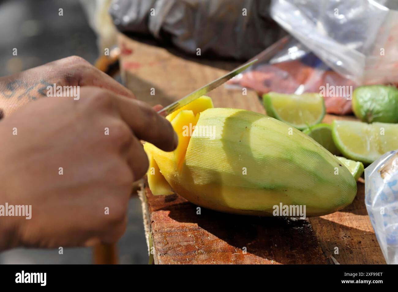 Merida, Yucatan, Mexico, Central America, person cutting a mango, close ...
