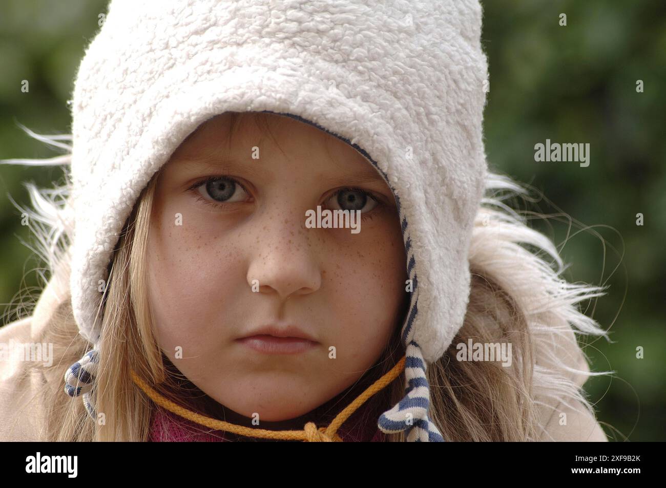 Sad looking little girl with cap, 5 years, Bavaria, Germany Stock Photo ...
