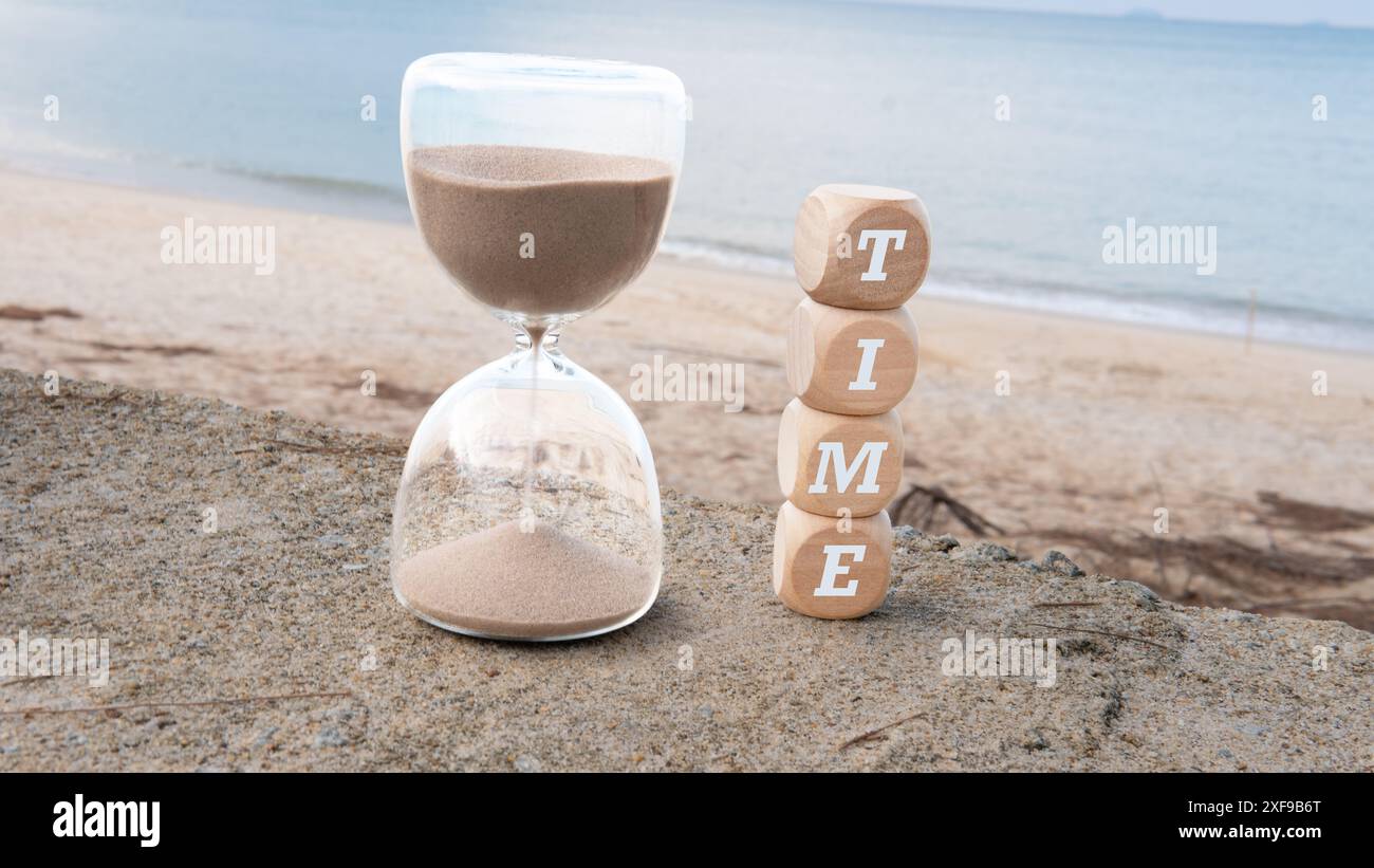 time concept with hourglass and sunrise at a beach. Time is gold quote ...