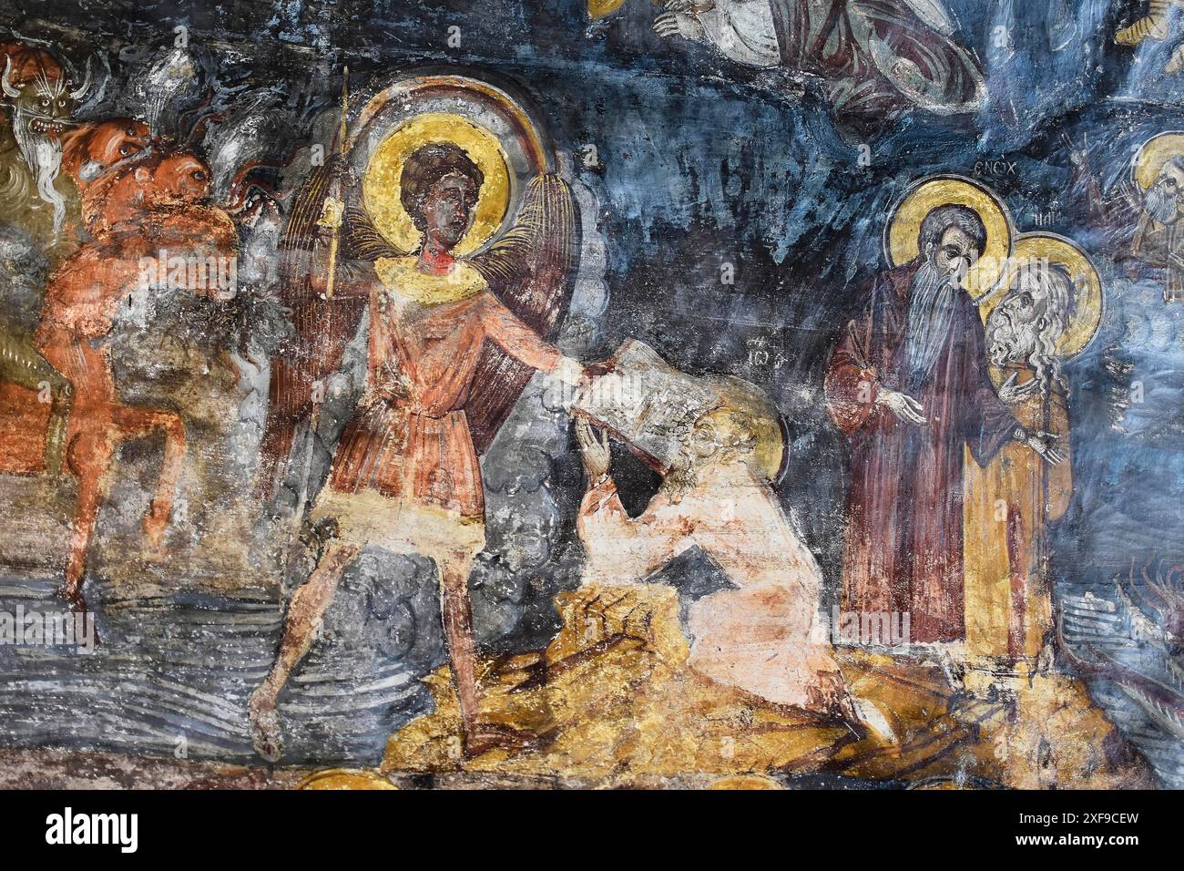 Fresco of a religious scene with saints, a kneeling martyr, a demonic ...