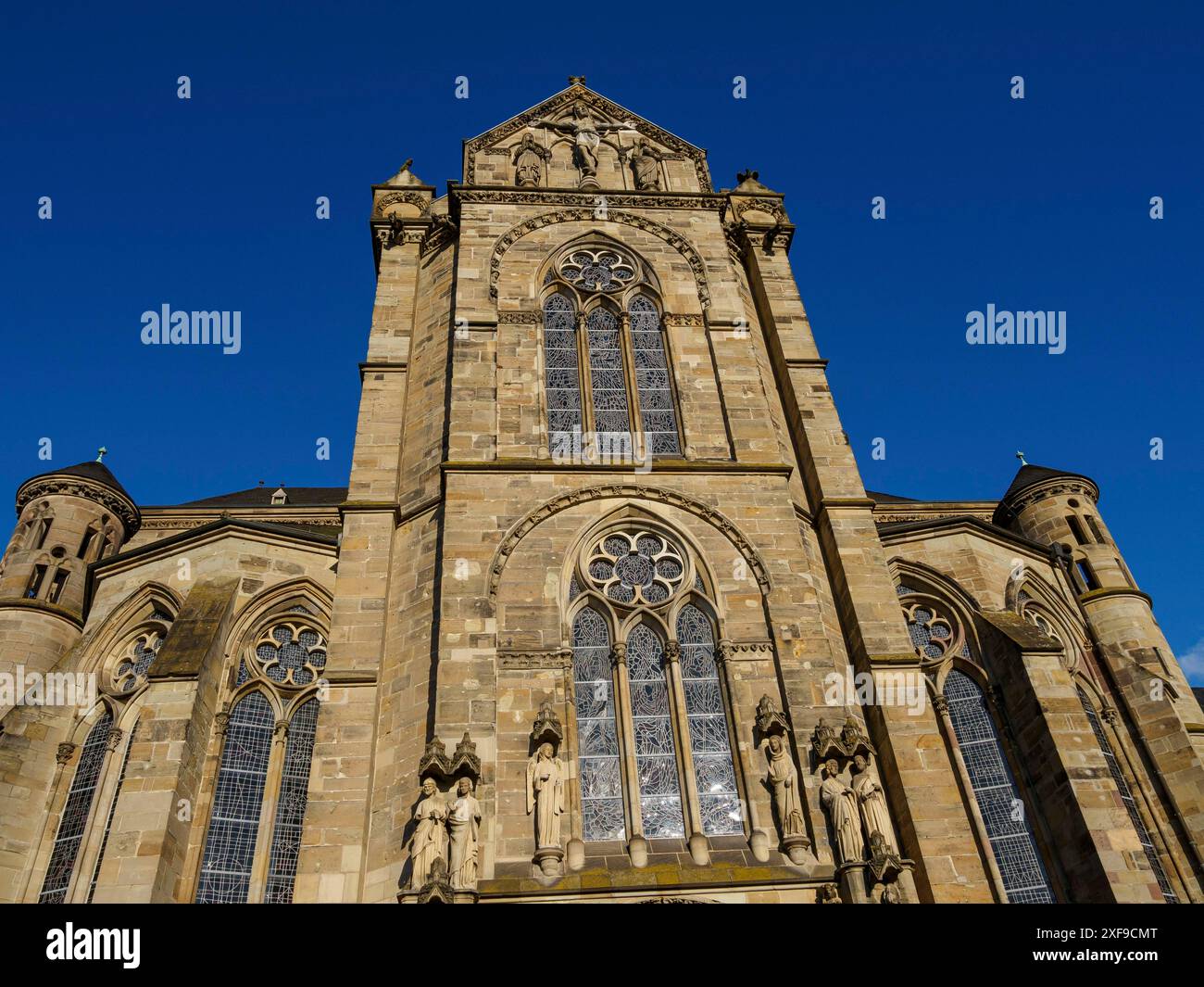Gothic cathedral with ornate windows, towers and statues under a clear ...