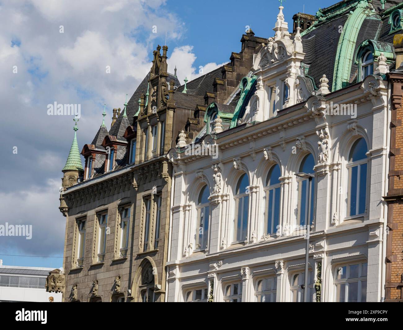 Historic buildings with elaborate facades and towers under a slightly ...