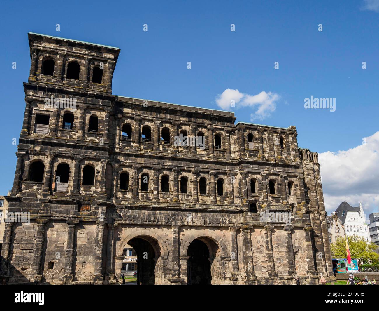Old stone structure with multiple levels and arches under a clear sky ...