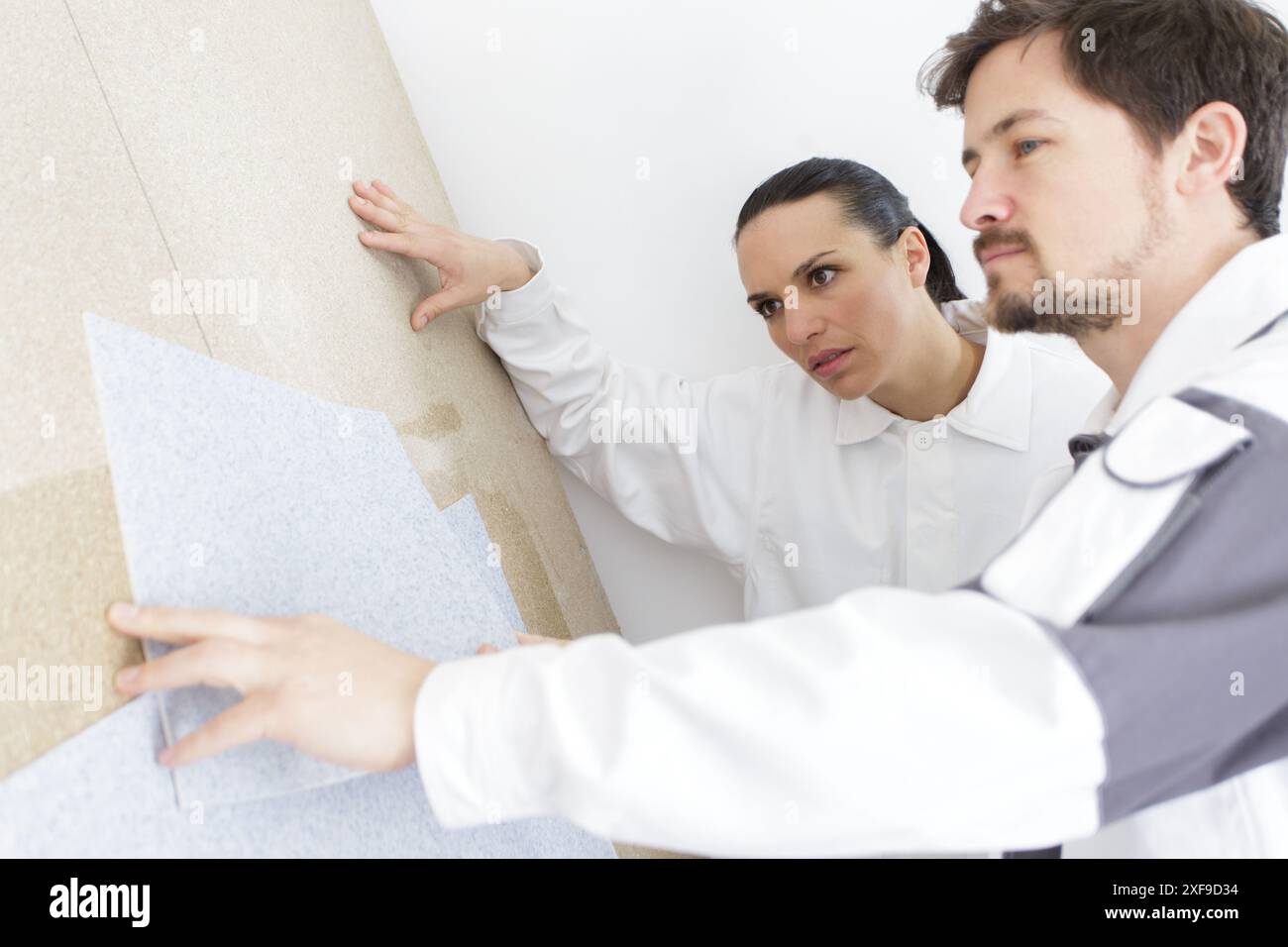 teal of workers during tile working Stock Photo - Alamy