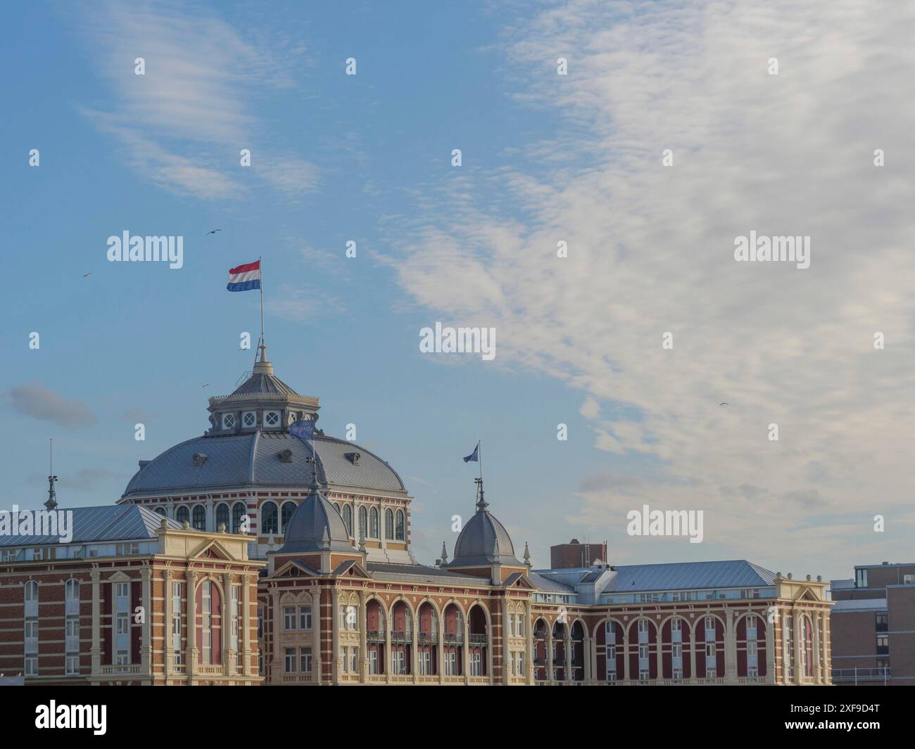 Magnificent historic architecture with a dome, crowned with flags ...