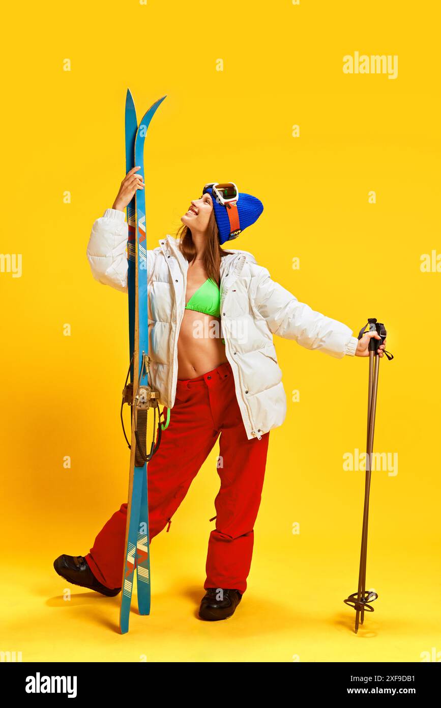 Happy woman in unique mix of winter sports attire and summer wear ...