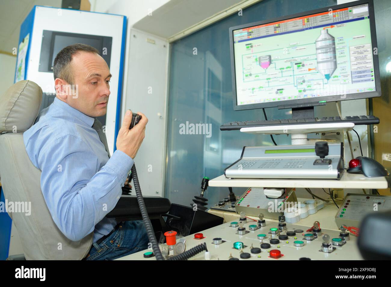 control center worker talking into radio receiver Stock Photo - Alamy