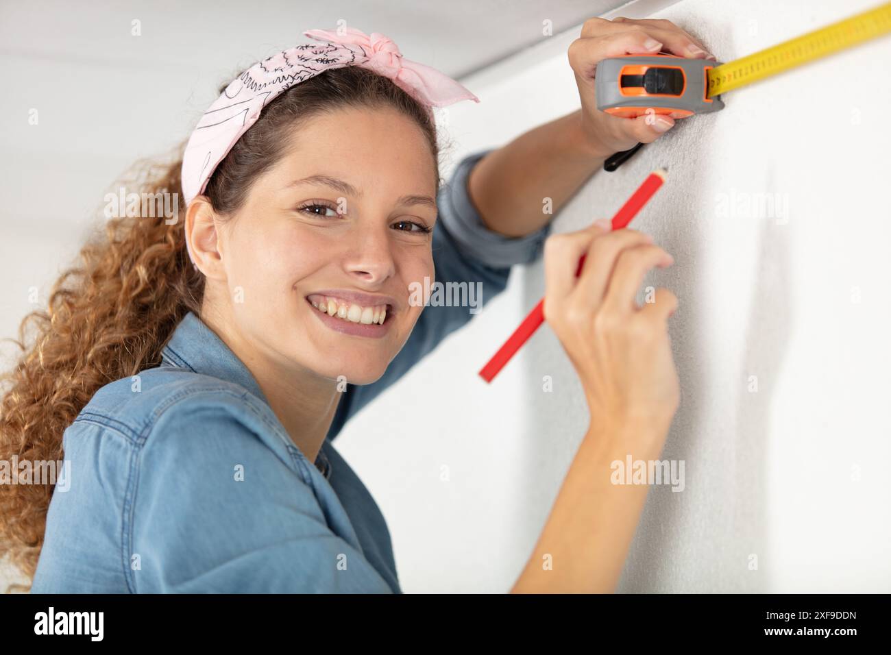 woman taking measures in living room Stock Photo - Alamy