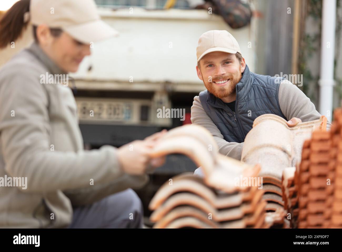 construction workers with tiles builders Stock Photo - Alamy
