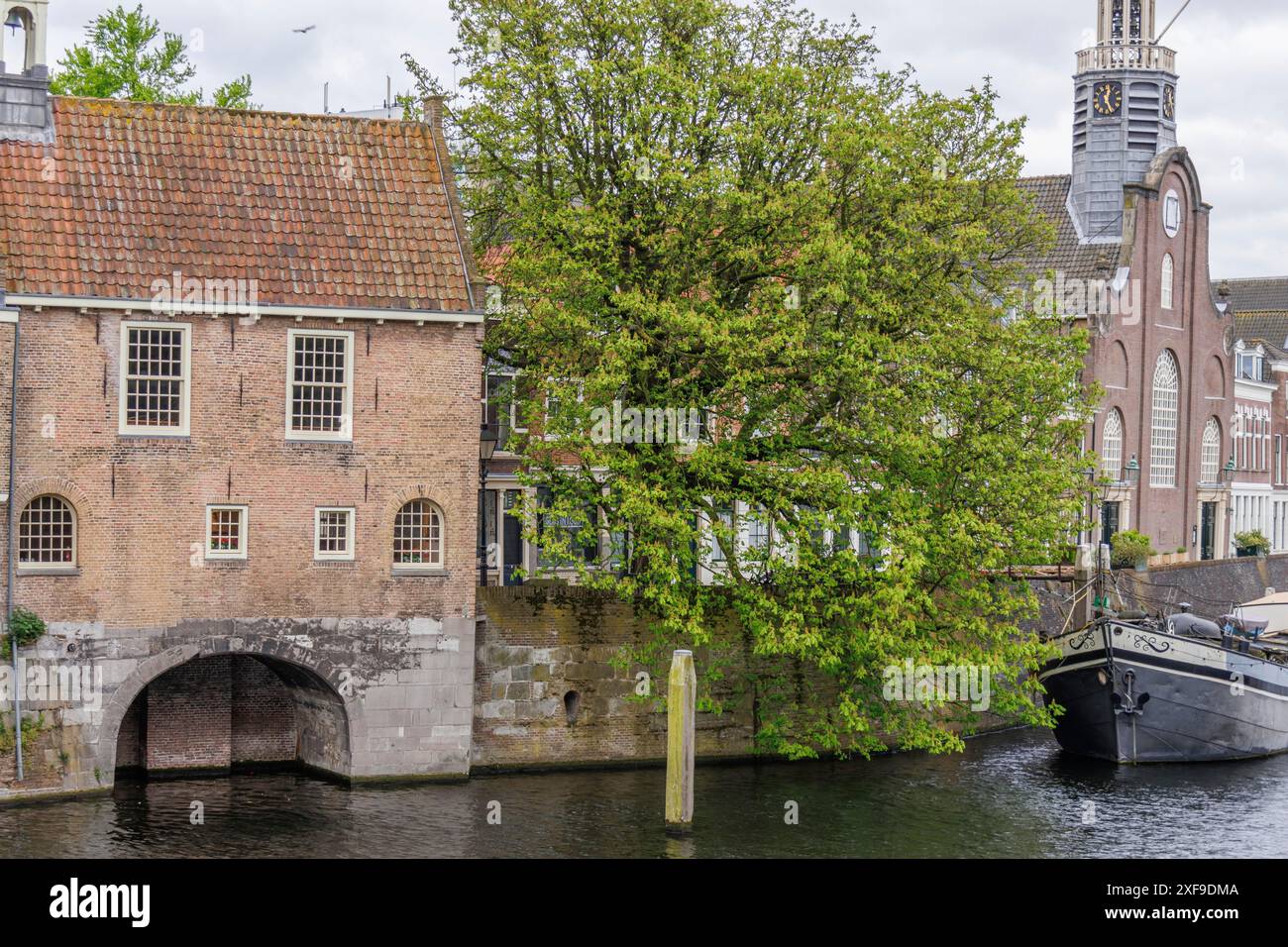 Canal with historic brick buildings, including a large building with ...