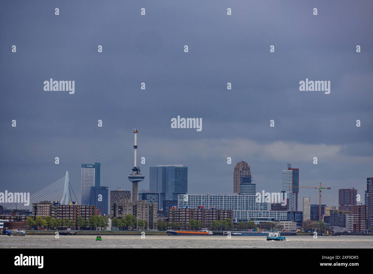 Modern city skyline with skyscrapers and a bridge. Cloudy sky ...