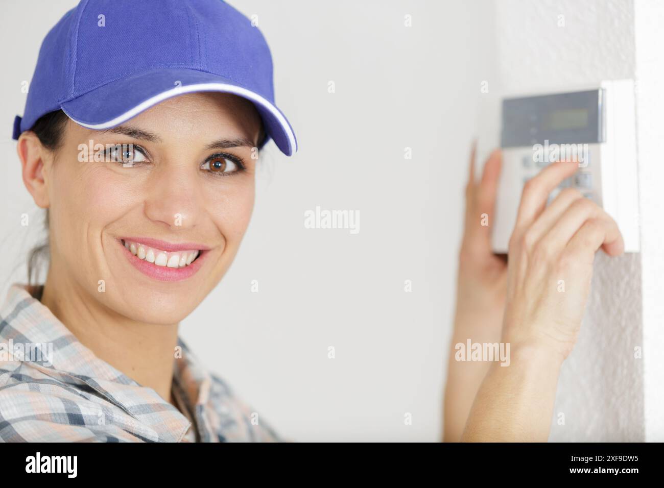 female technician installing security system Stock Photo - Alamy