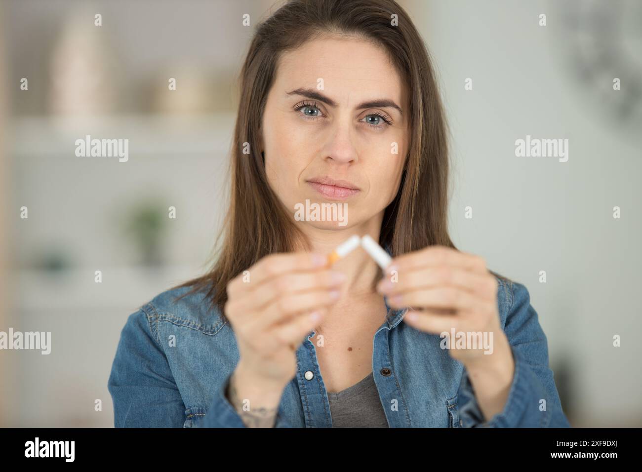 beautiful woman breaks a cigarette Stock Photo - Alamy