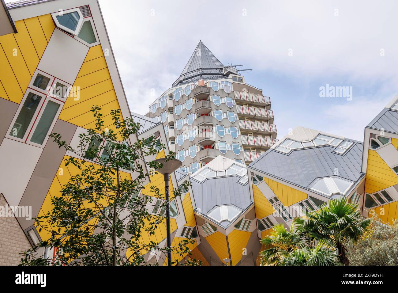Cube houses with yellow facades and slanted windows, in the background ...