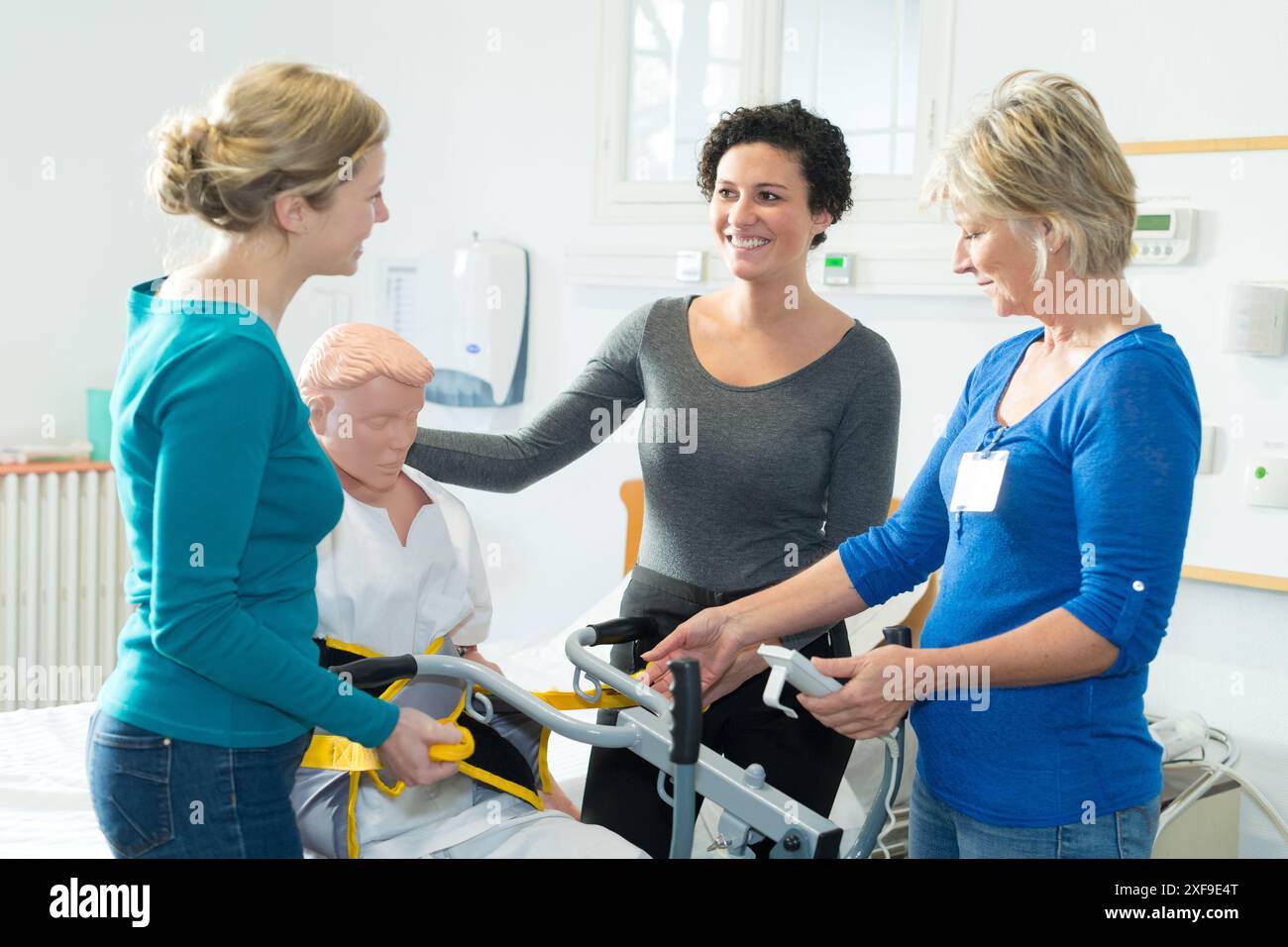 nurses practicing procedure to lift disabled patient from bed Stock ...