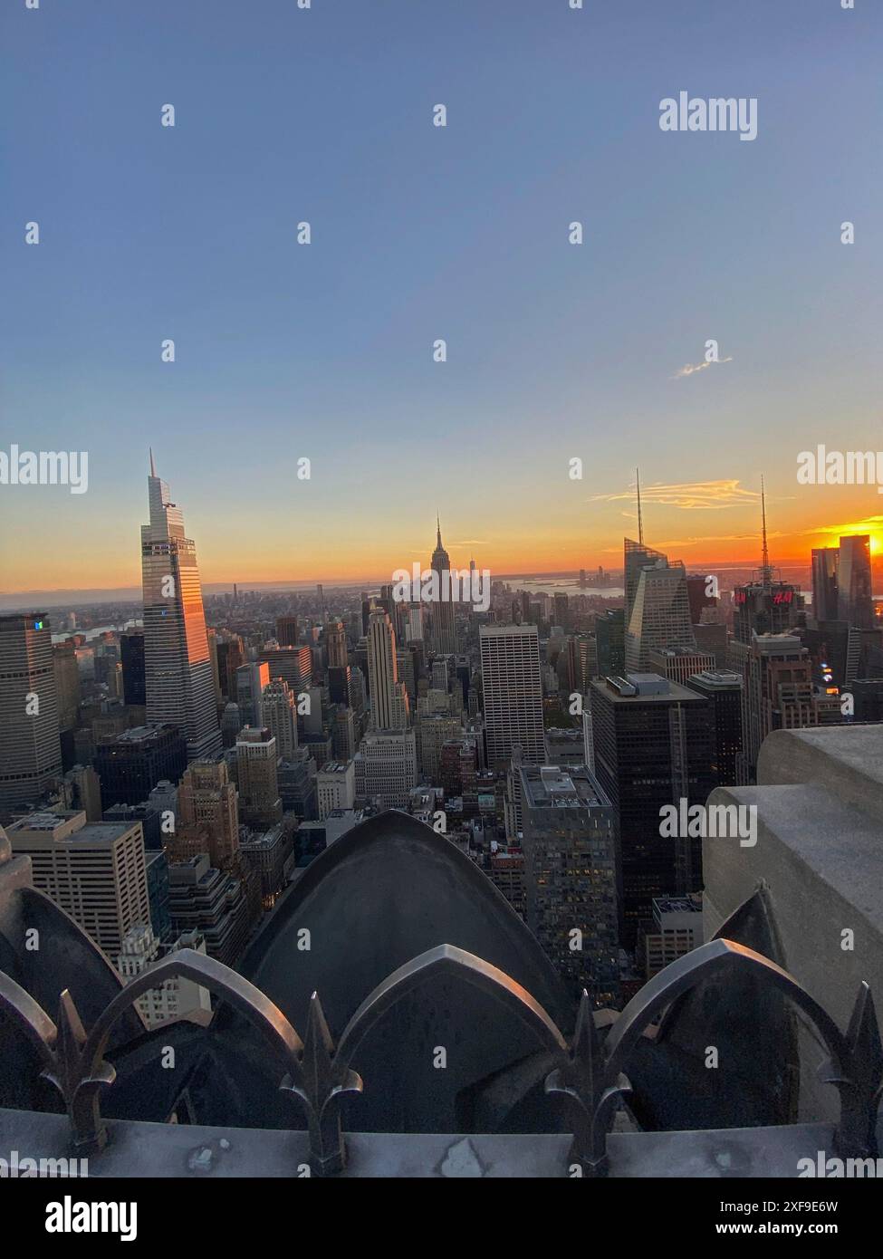 Skyline of New York at sunrise, the skyscrapers catch the first rays of ...