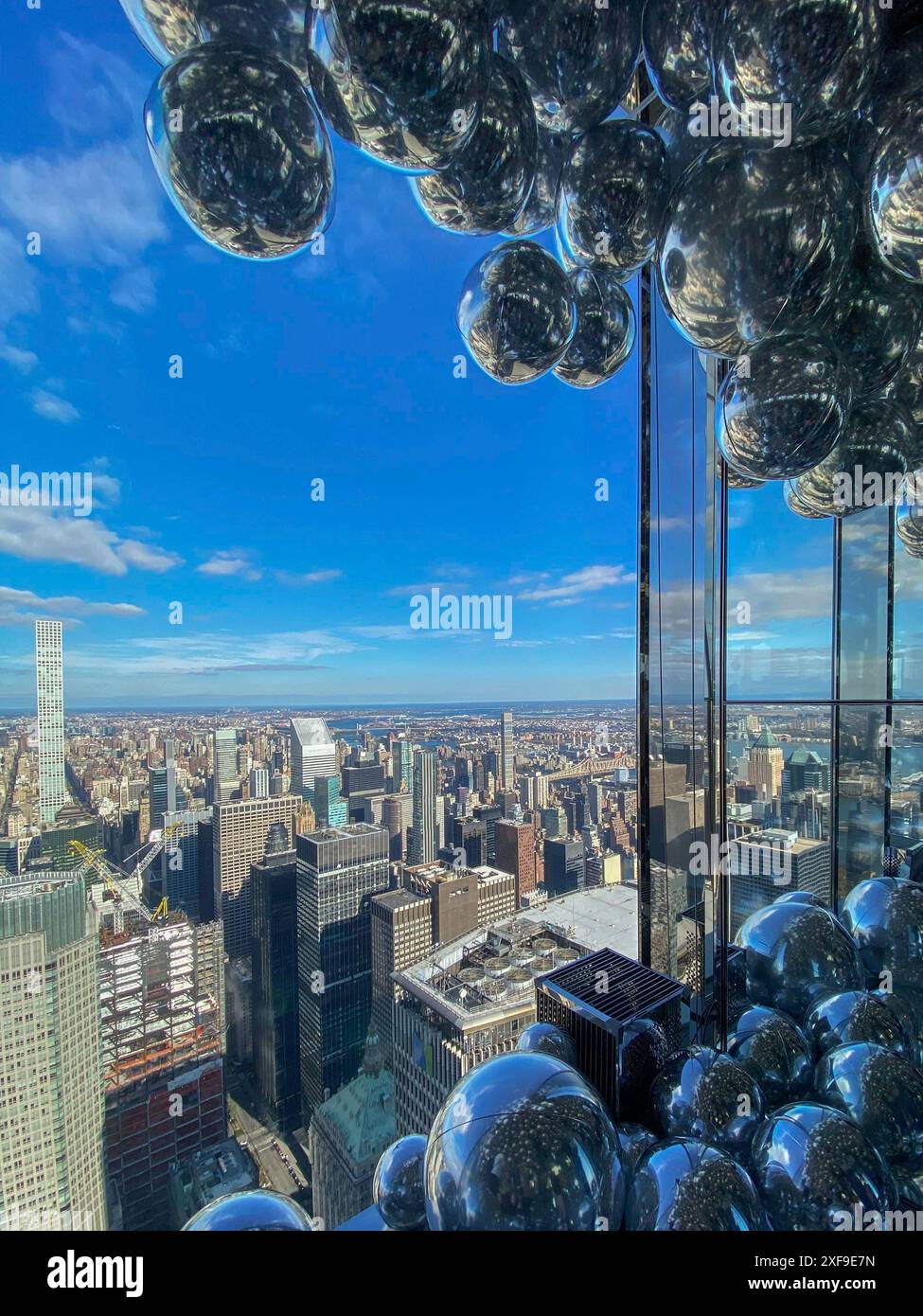 City skyline observed through facade and reflection of shiny balloons ...