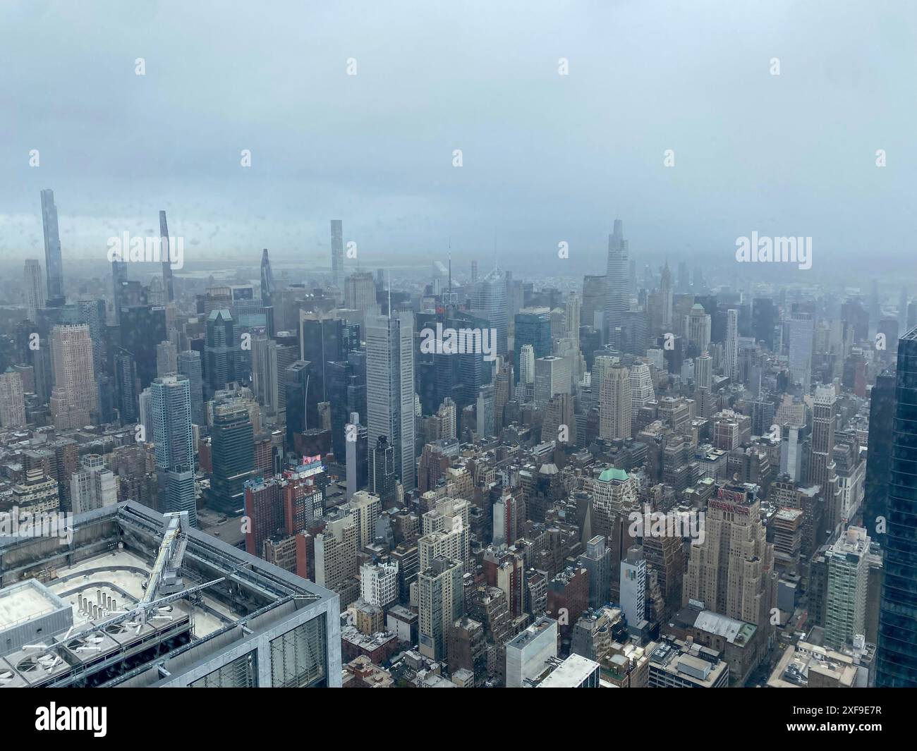 Hazy view of a city with numerous skyscrapers and tall buildings under ...