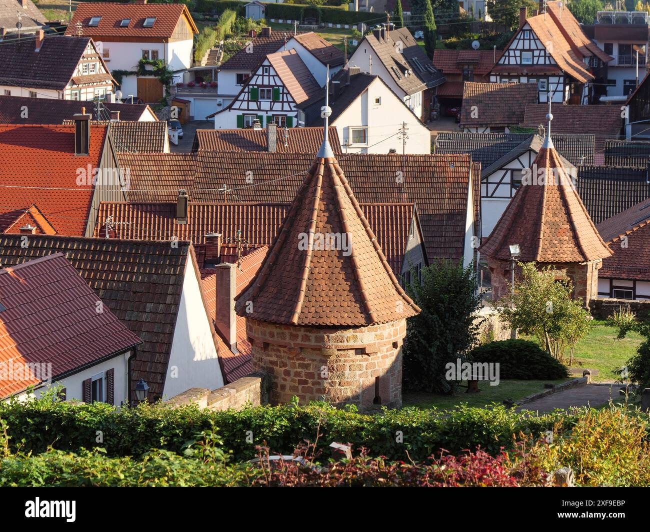 Traditional village view with many tiled roofs and towers. Numerous ...