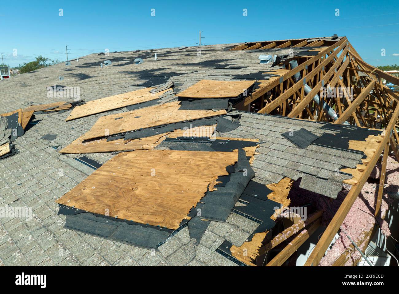 Ruined rooftop in need of repair. Wind damaged house roof with missing ...