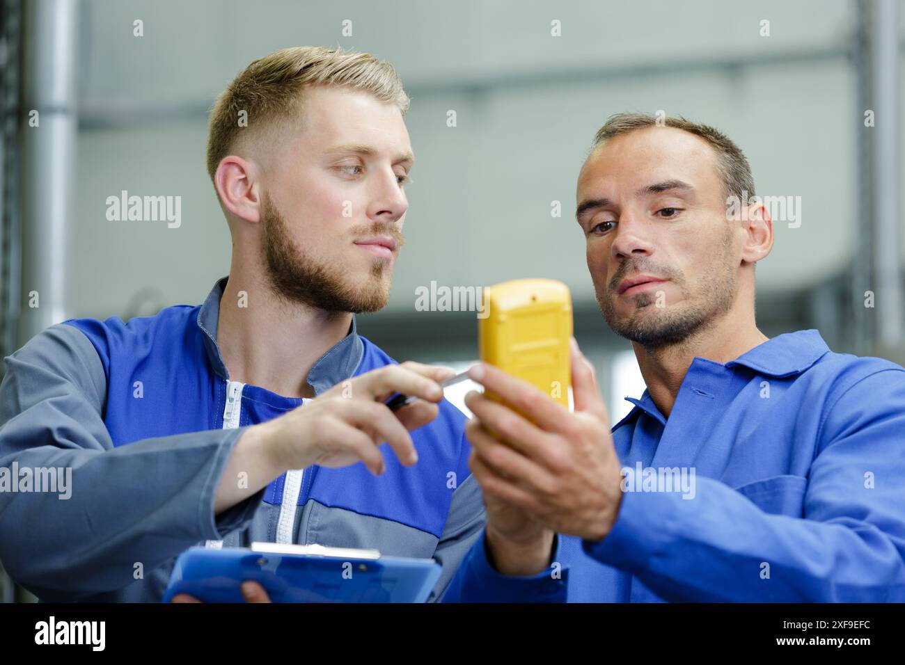 two engineer working on maintenance equipment Stock Photo - Alamy