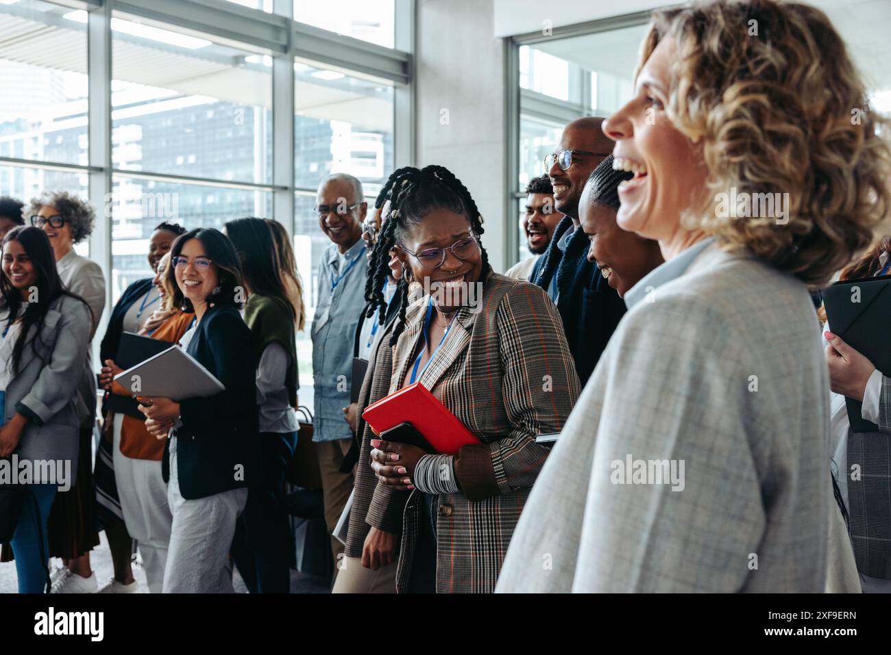 Business professionals engaging and laughing together during a lively ...